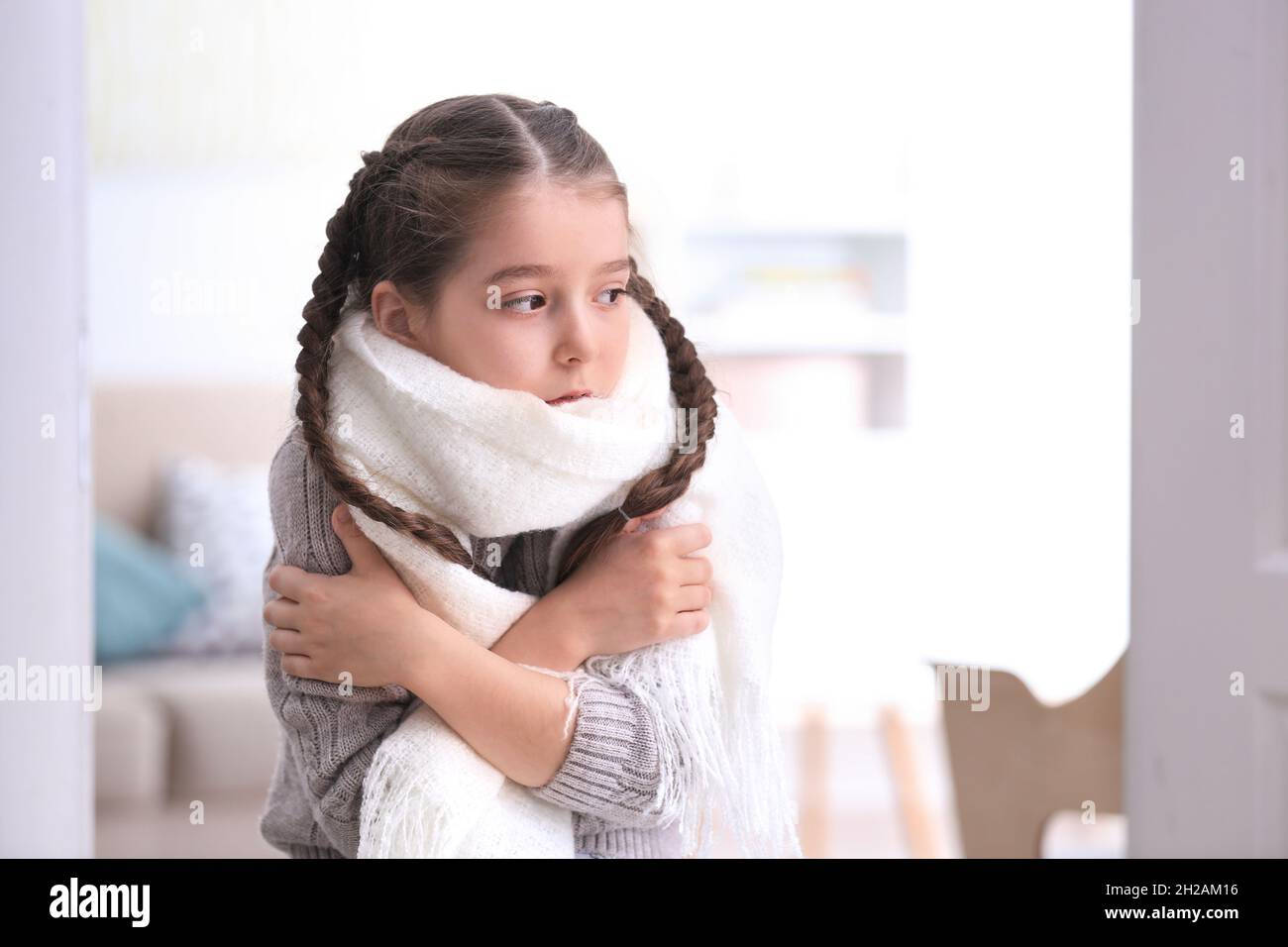 Sad little girl suffering from cold on blurred background Stock Photo ...