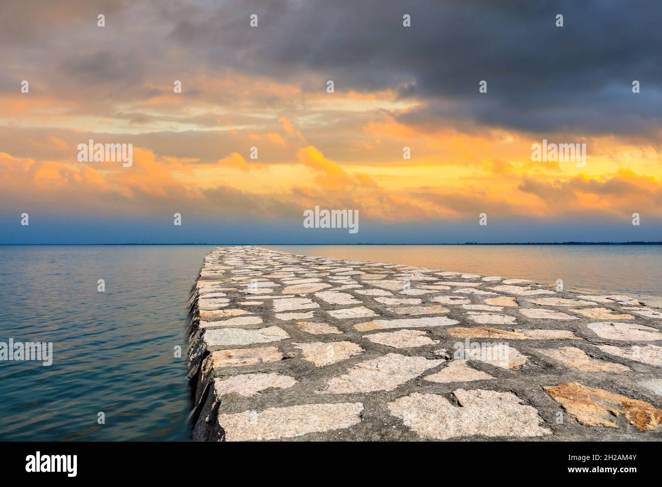 Stone path and lake landscape at sunrise Stock Photo - Alamy