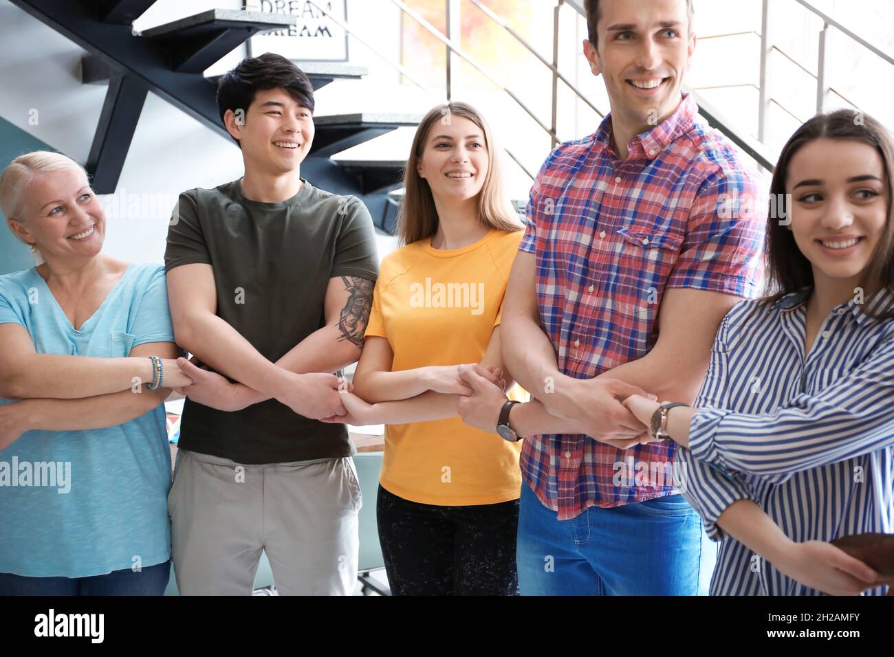 People holding hands on light background. Unity concept Stock Photo - Alamy