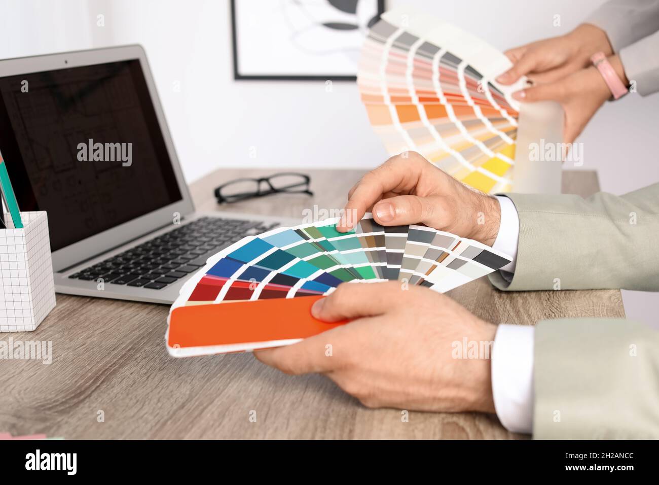 Team of designers working with color palettes at office table, closeup ...