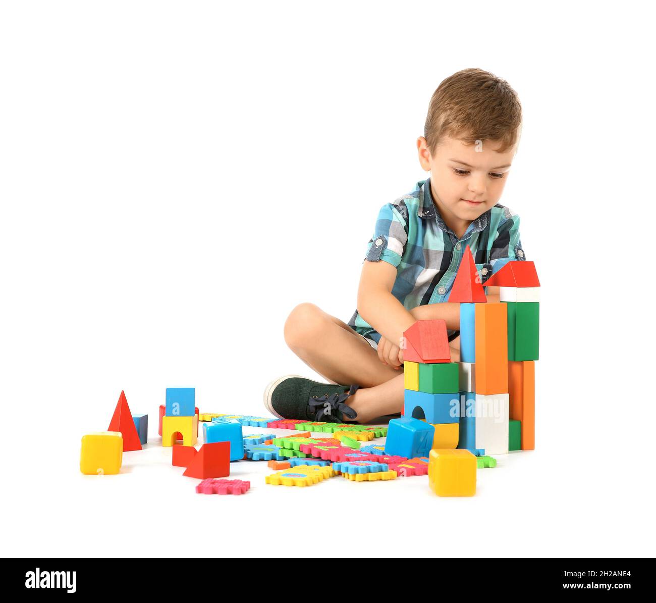 Little child playing with blocks on white background. Indoor recreation ...