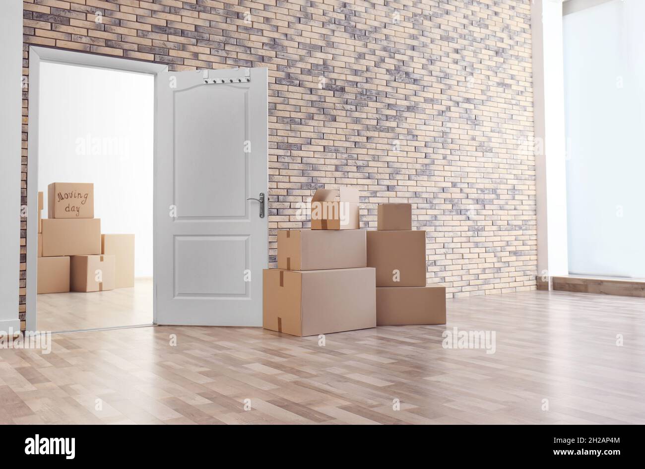 Pile of moving boxes in empty room Stock Photo - Alamy