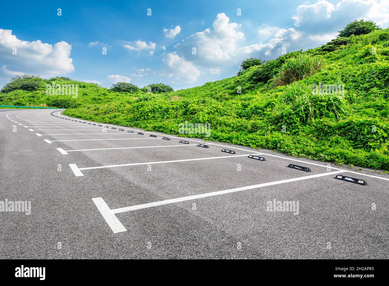 Asphalt parking lot and green mountain nature landscape Stock Photo - Alamy