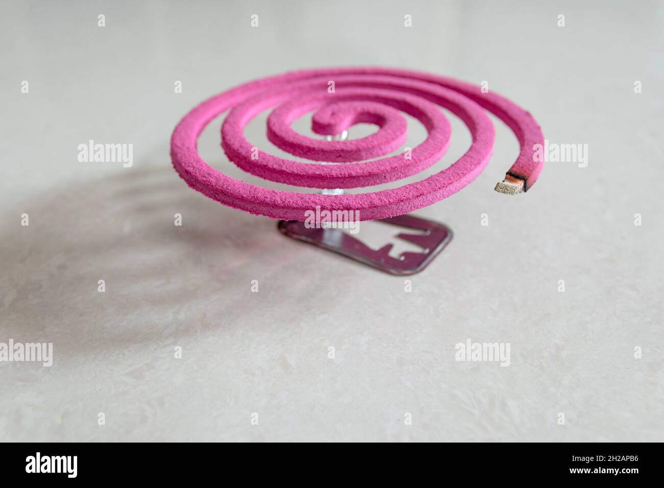 Pink mosquito repellent on white background Stock Photo - Alamy