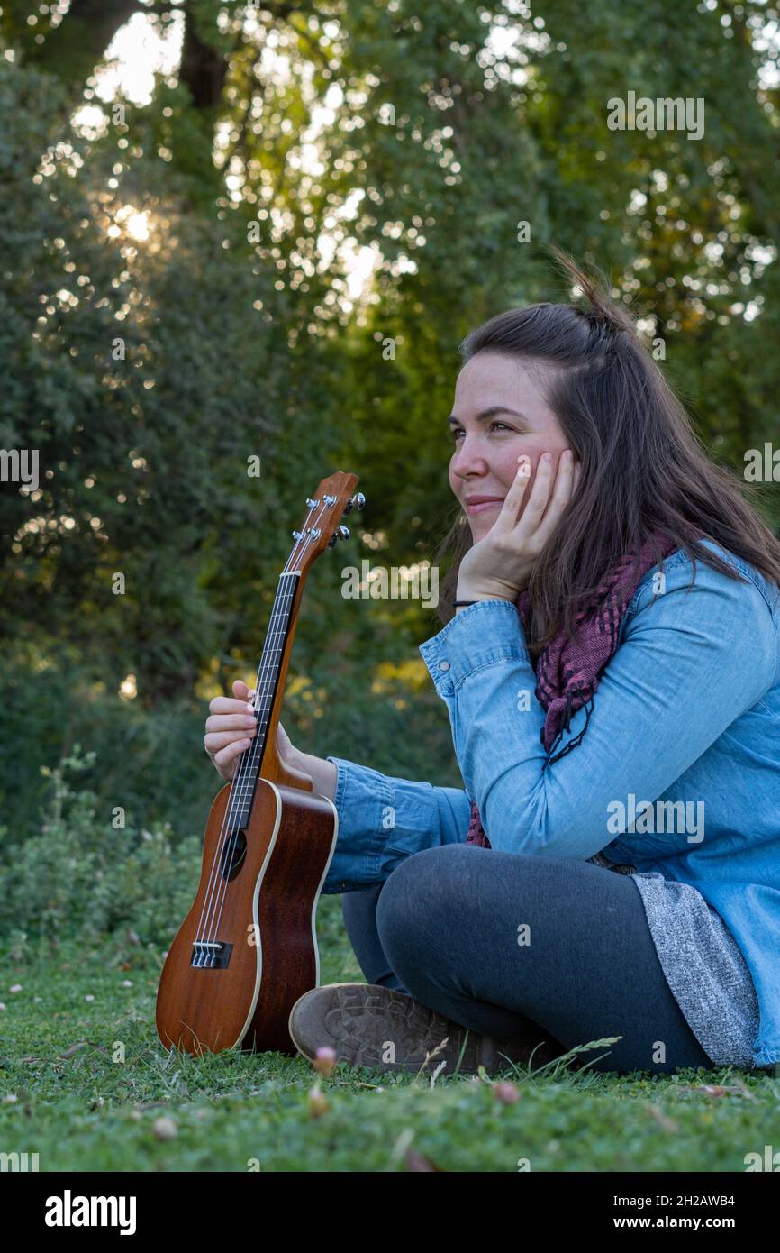girl playing the ukulele Stock Photo - Alamy