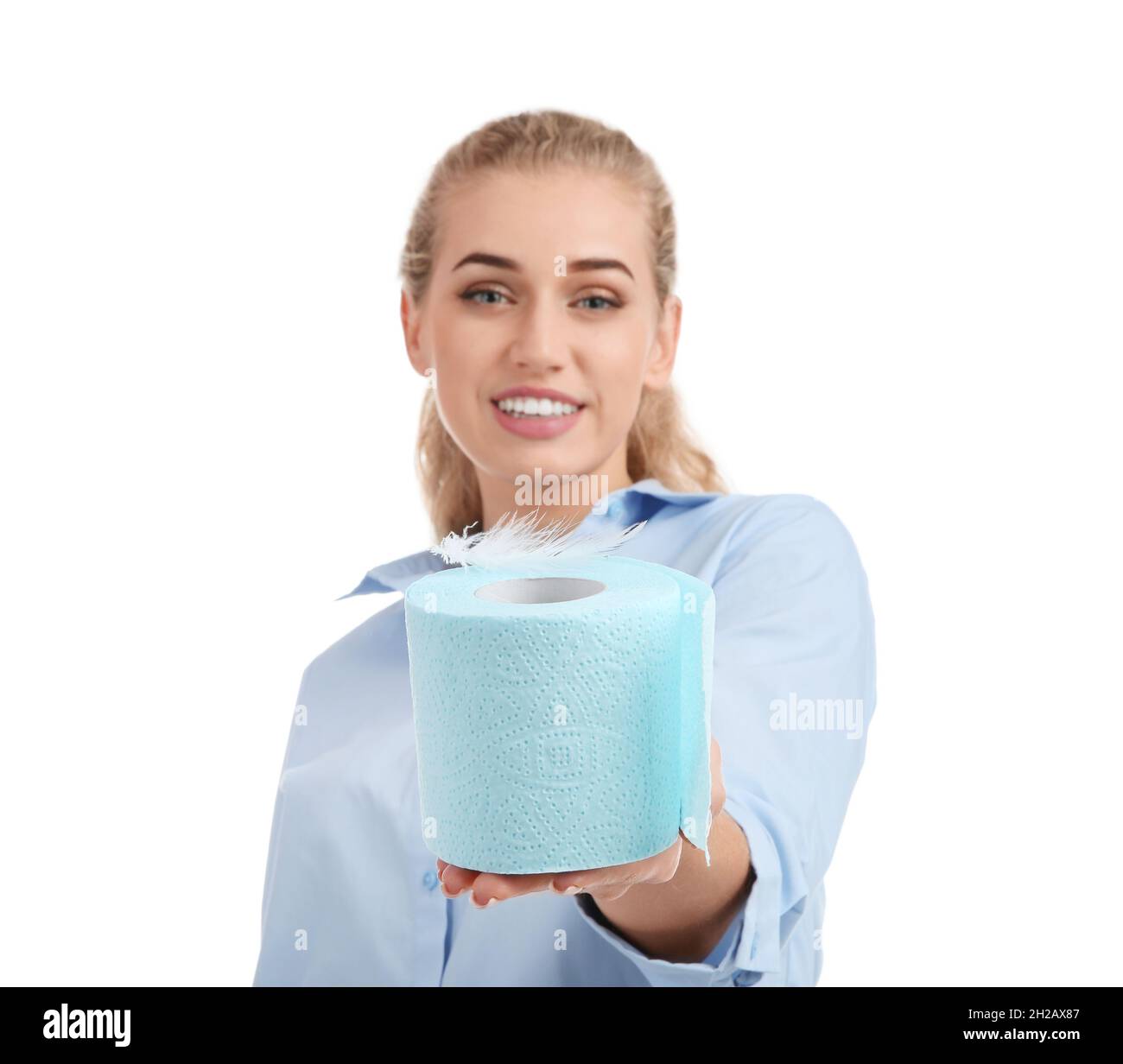 Beautiful young woman holding toilet paper roll on white background ...