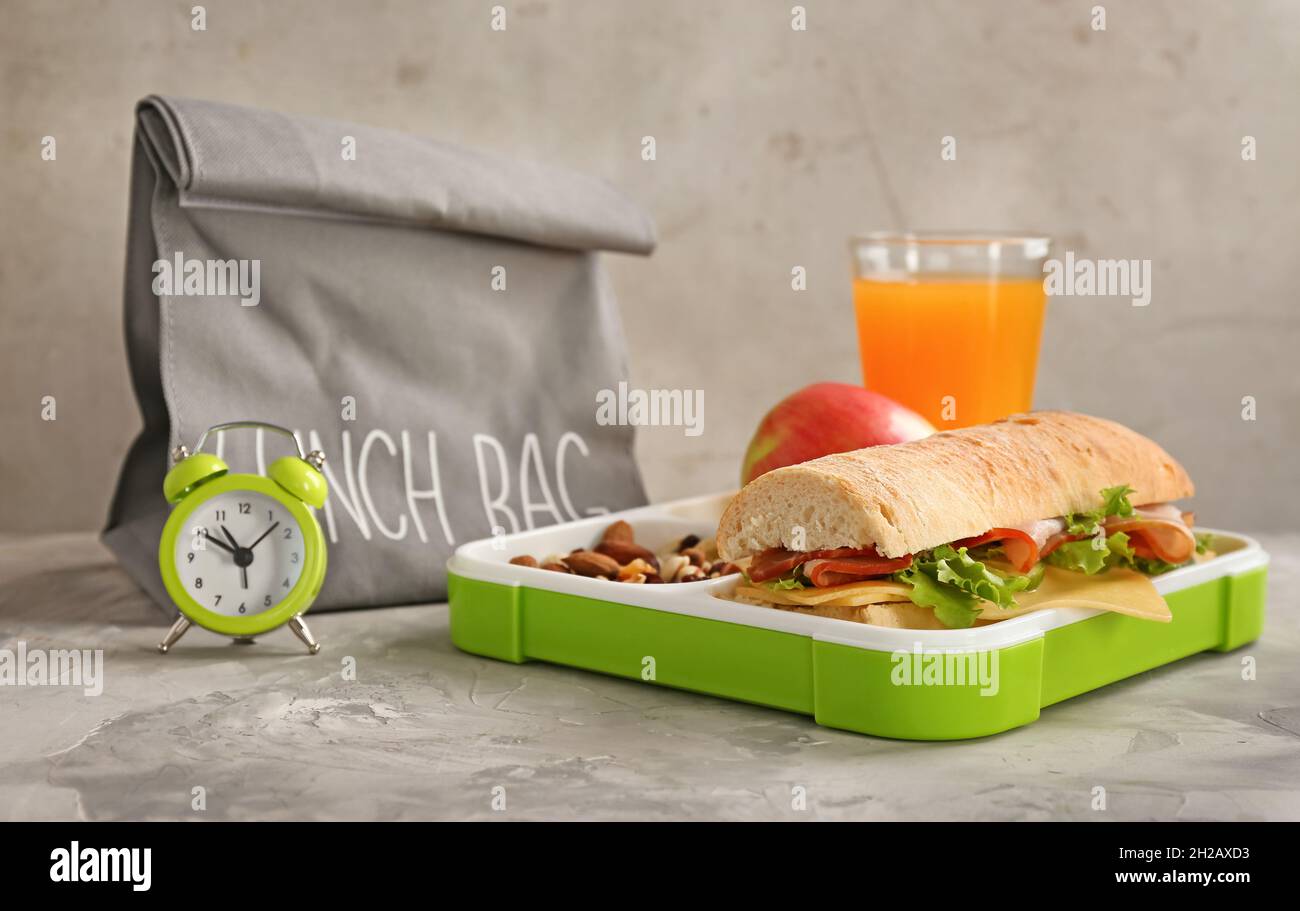 Composition with lunch box on gray background Stock Photo - Alamy