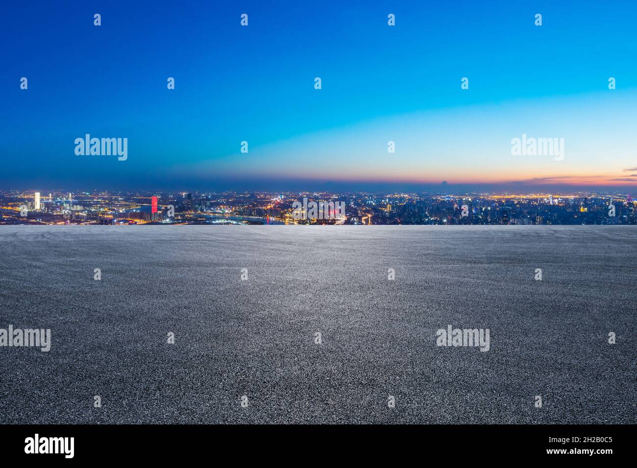 Race track road and city skyline with buildings at night in Shanghai ...