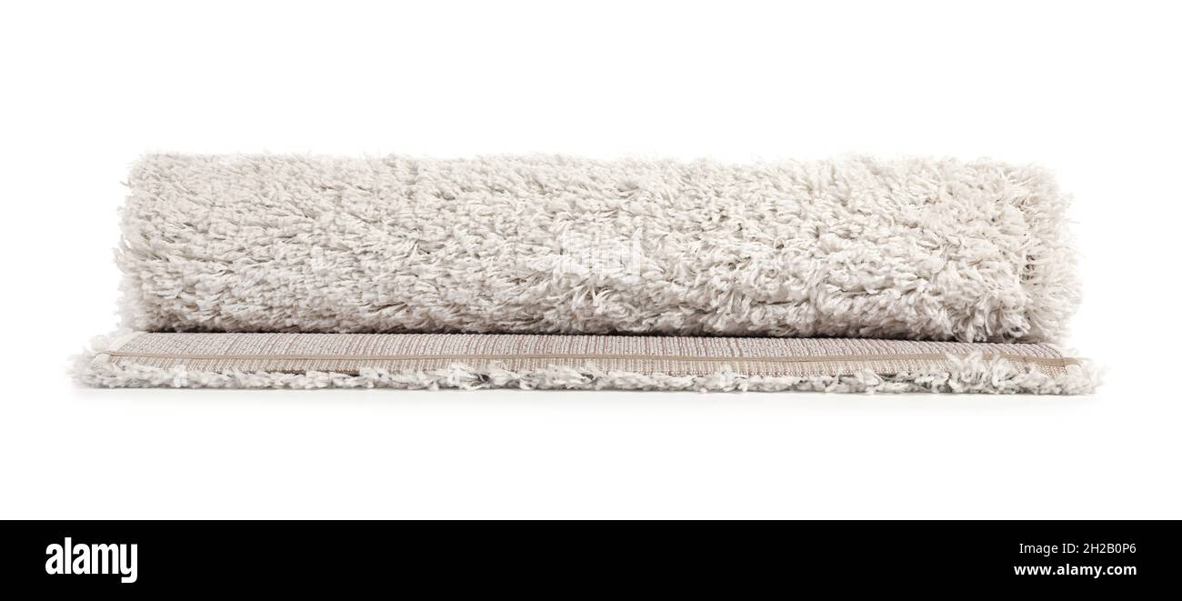 Rolled fuzzy carpet on white background. Interior element Stock Photo ...