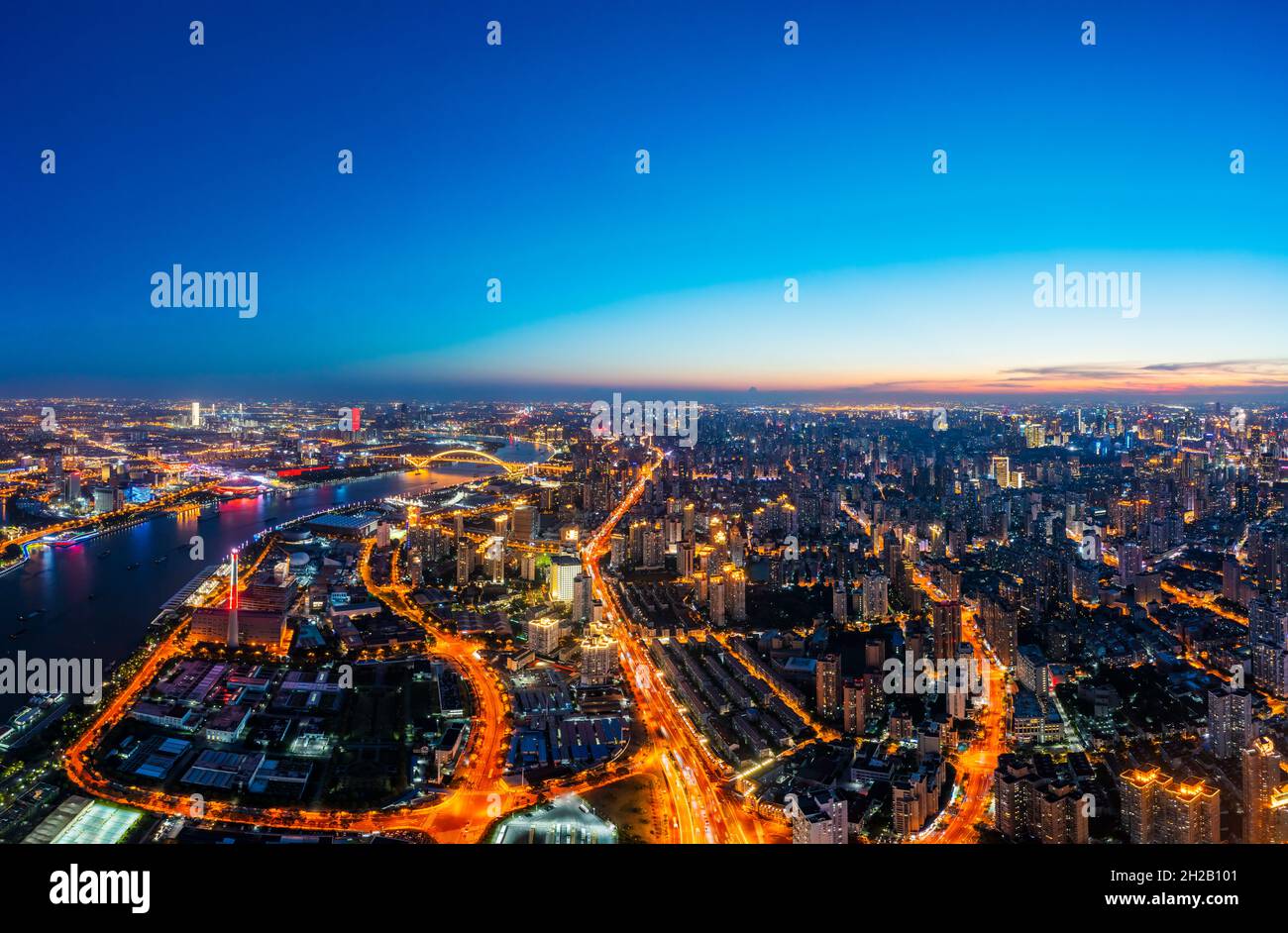 Aerial view of modern city skyline and buildings at night in Shanghai ...