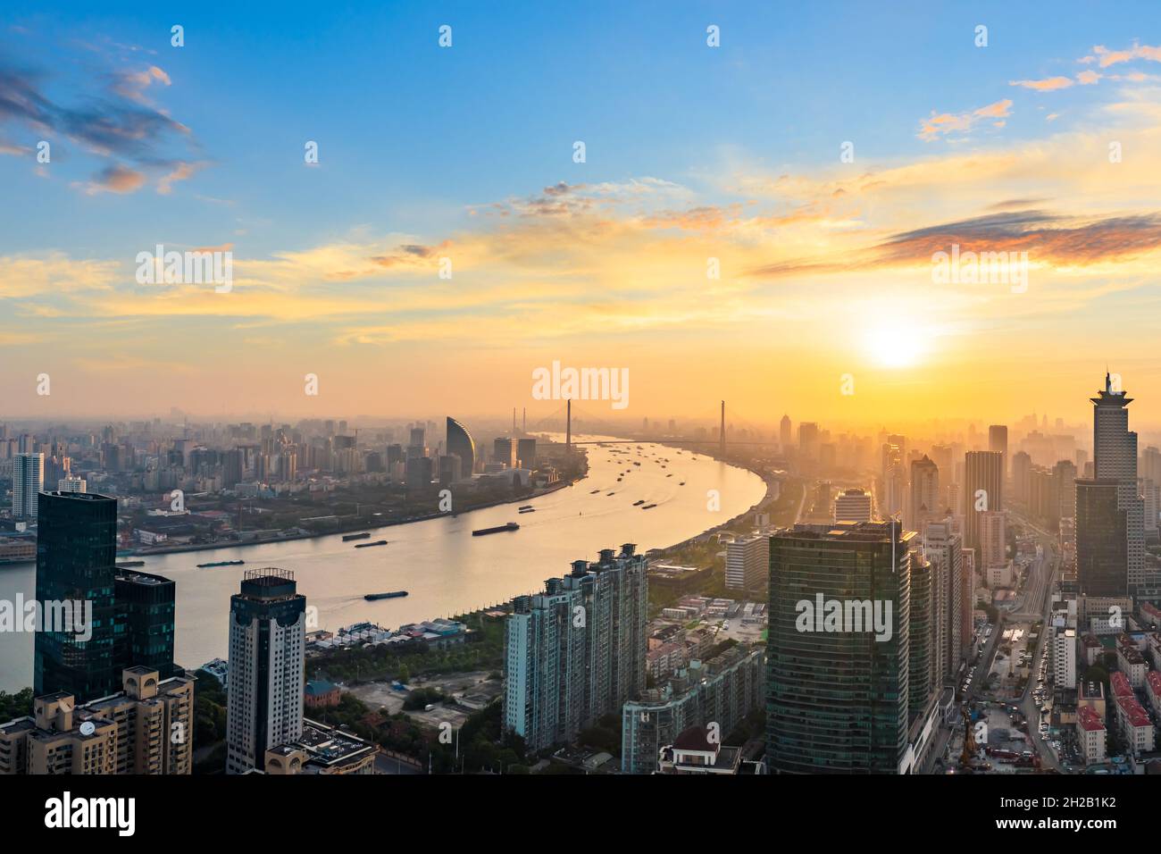 Aerial view of modern city skyline and buildings at sunrise in Shanghai ...