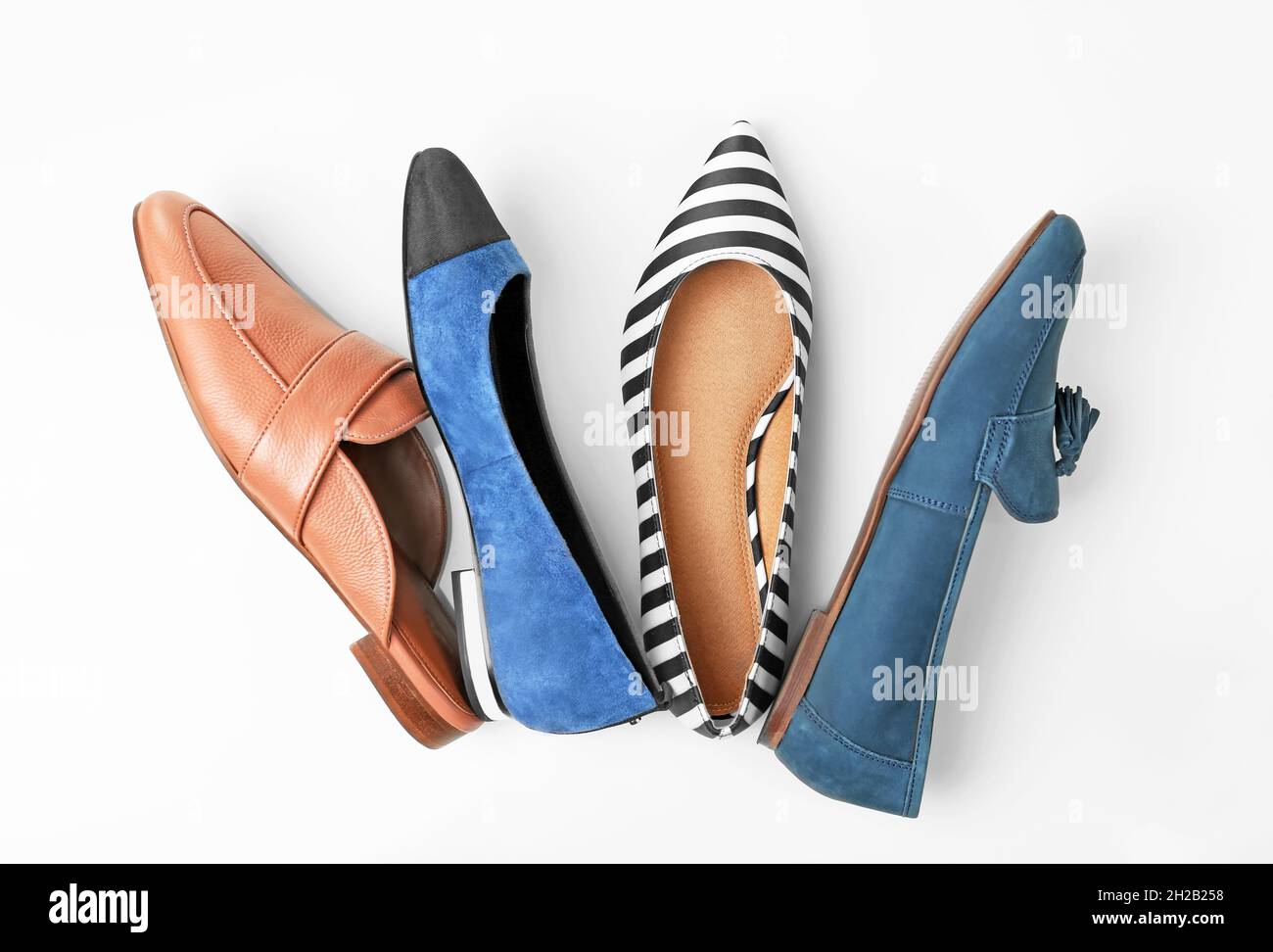 Different female shoes on white background, top view Stock Photo - Alamy
