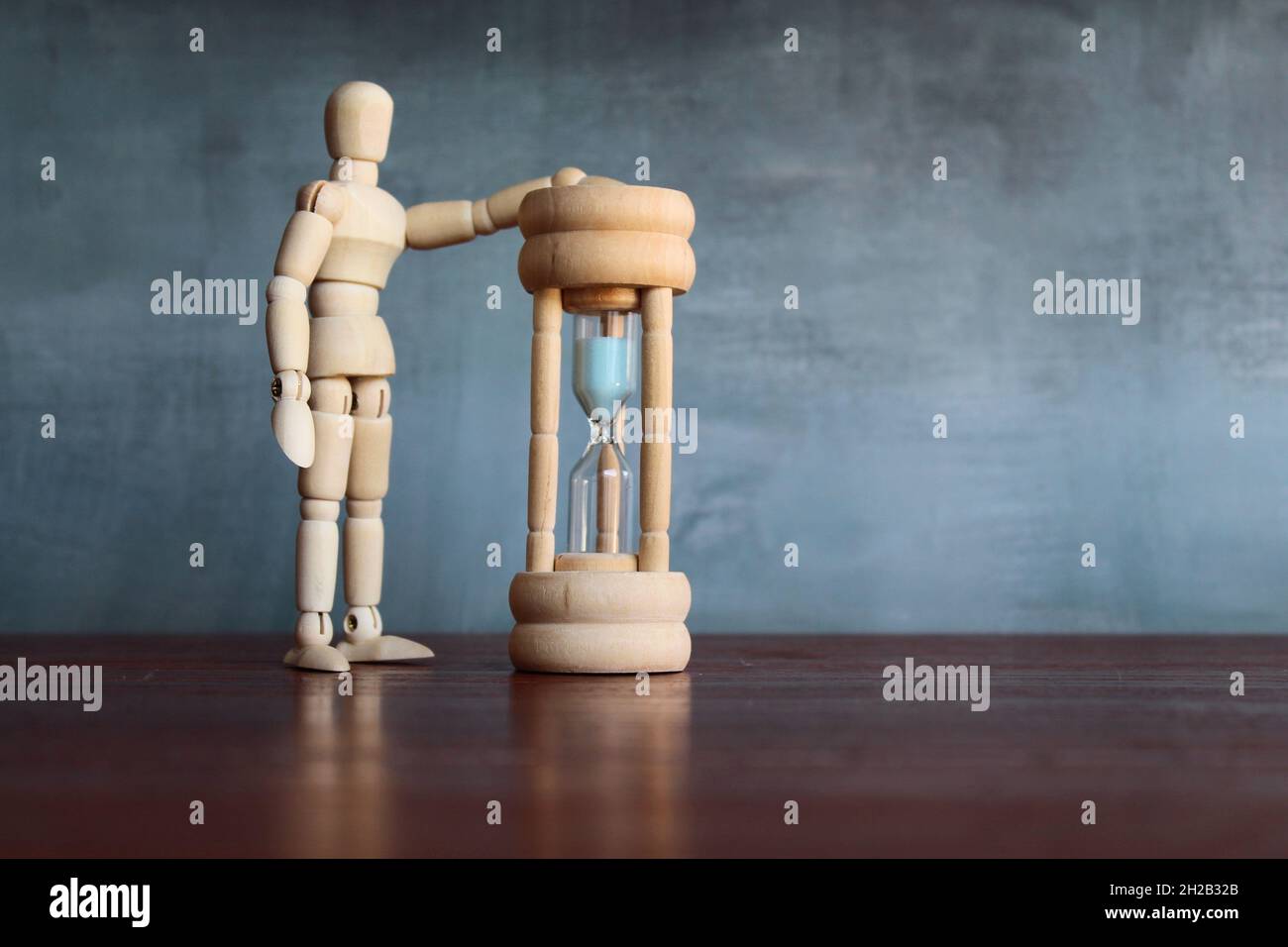 Time management, waiting time concept. Wooden human figure look at the ...