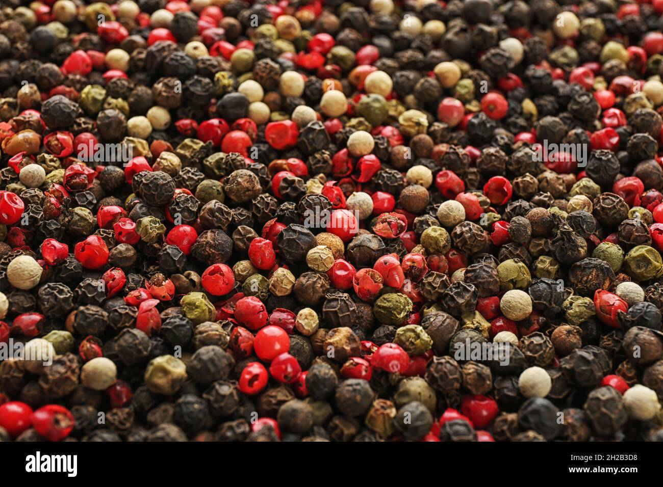 Different types of pepper as background. Natural spice Stock Photo - Alamy
