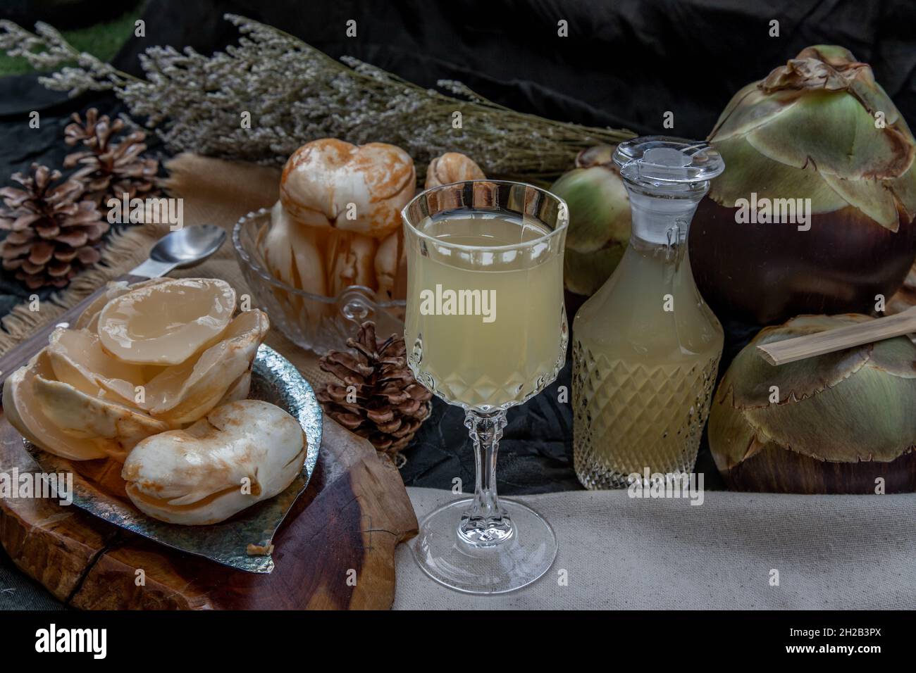 Fresh toddy palm juice and Peel toddy palm at front of dark background ...