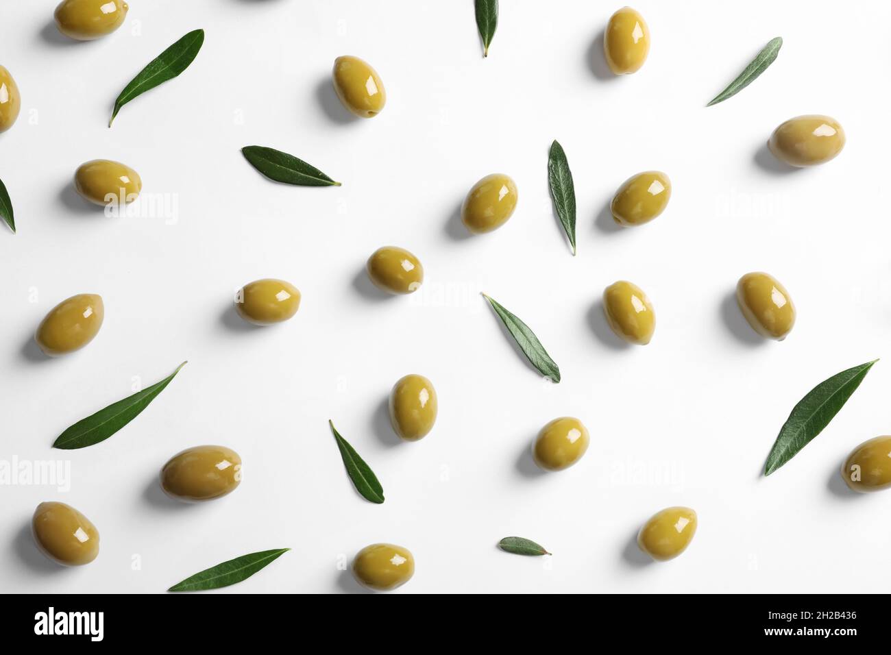 Flat lay composition with fresh olives covered with oil on white ...