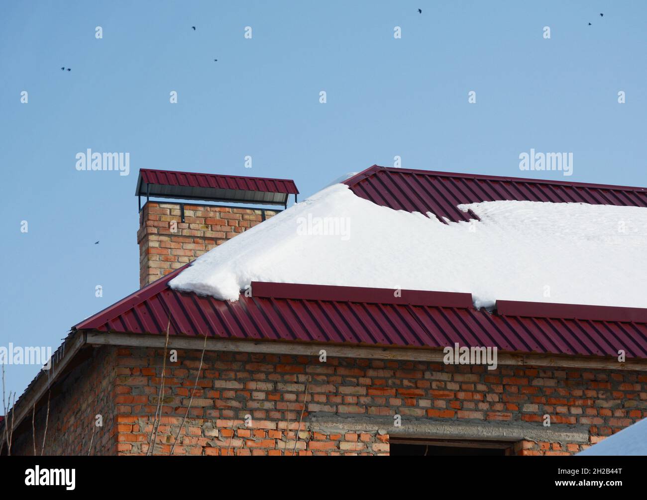 Close up on metal roofing with roof protection from snow board, snow ...