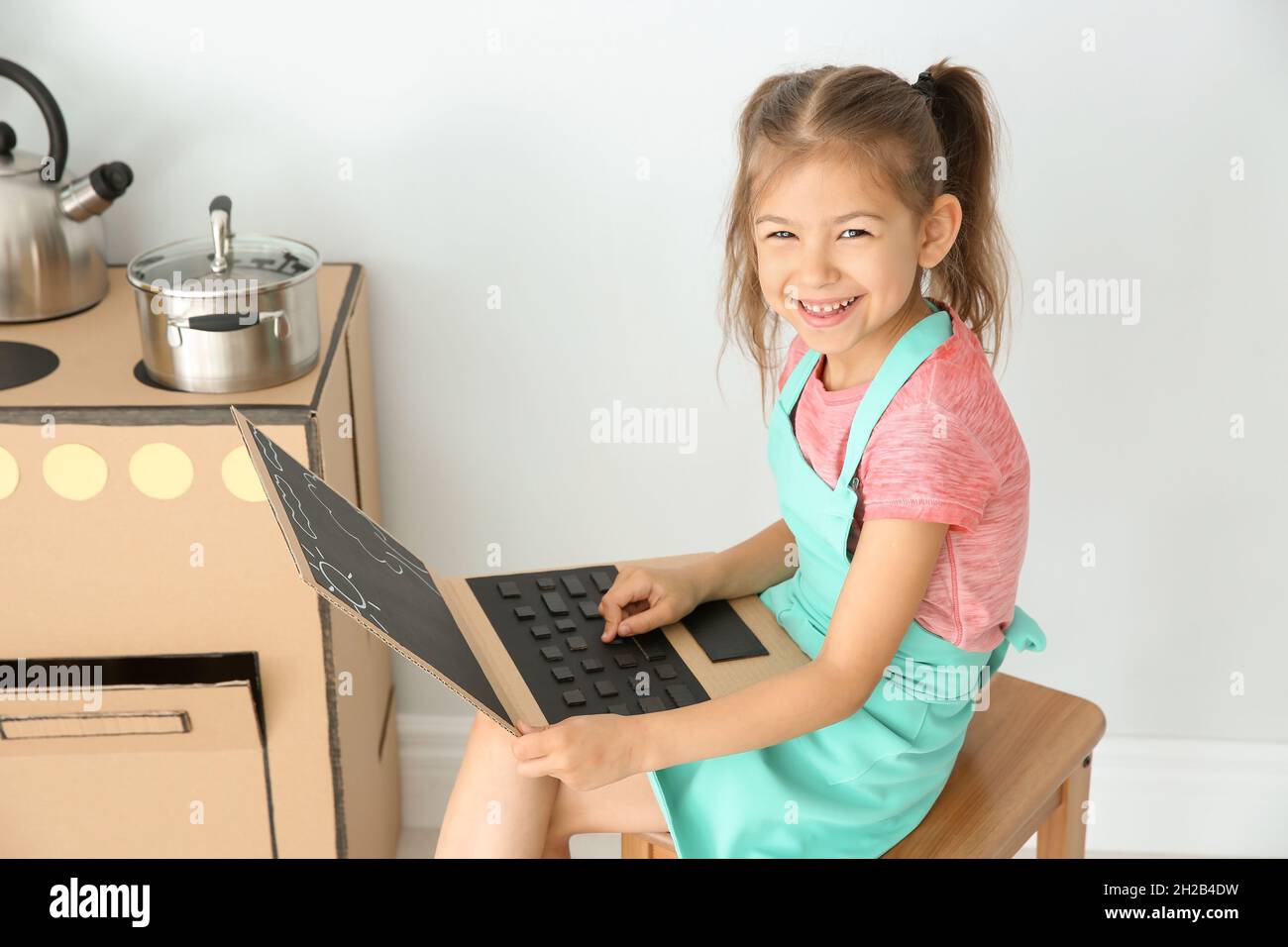Little child playing with carton laptop indoors Stock Photo - Alamy