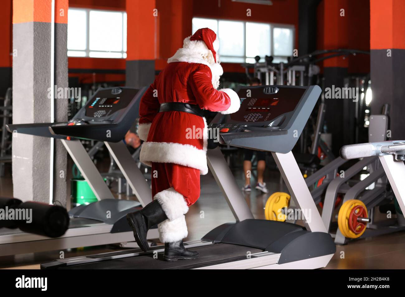 Authentic Santa Claus training on treadmill in modern gym Stock Photo ...