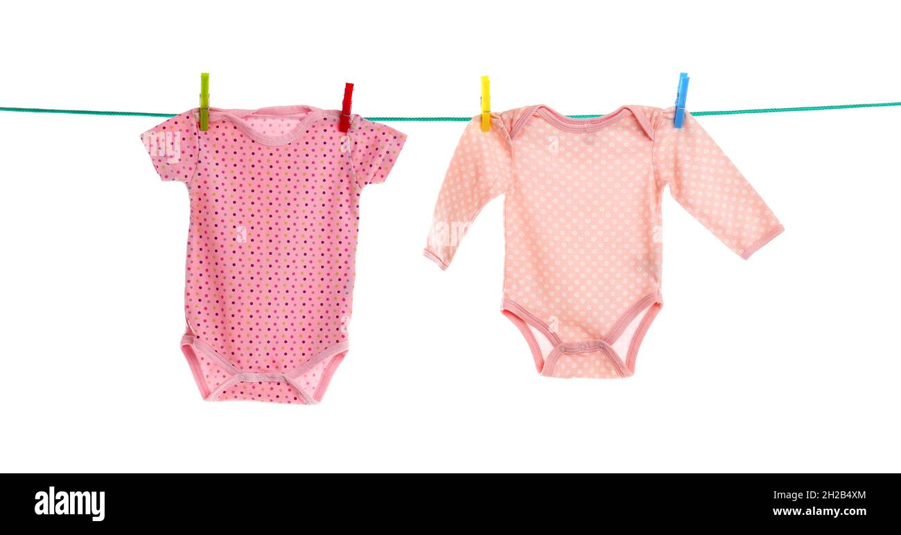 Baby clothes on laundry line against white background Stock Photo - Alamy