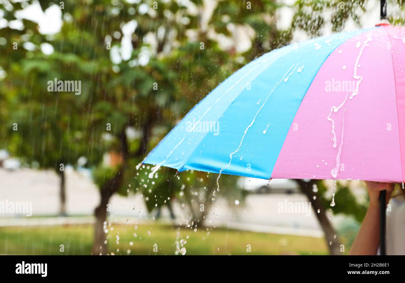 Person with bright umbrella under rain on street, closeup Stock Photo ...