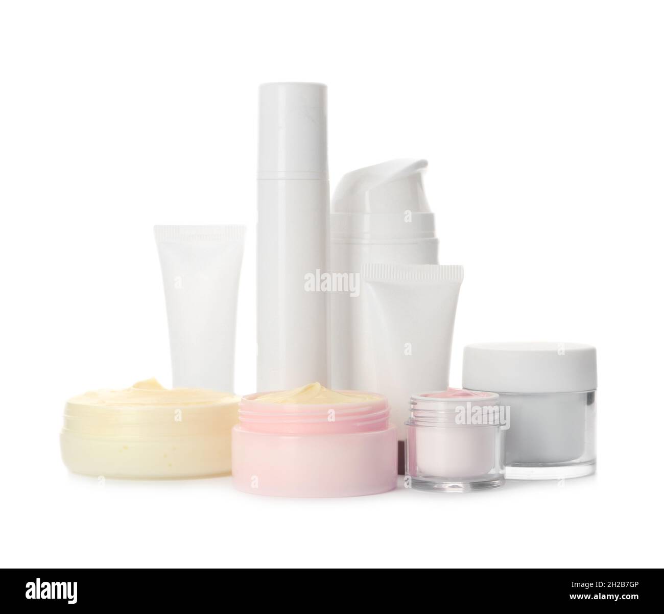 Different containers with hand cream and other cosmetic on white ...