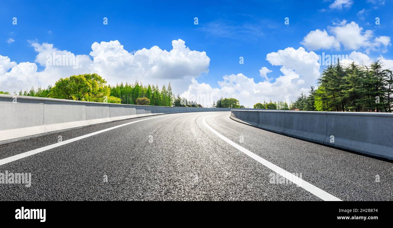 Empty asphalt road and green trees in spring season Stock Photo - Alamy