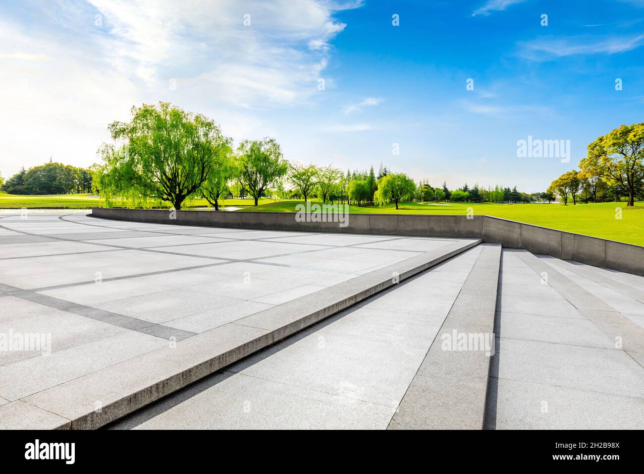 Wide square floor and green trees in natural park Stock Photo - Alamy