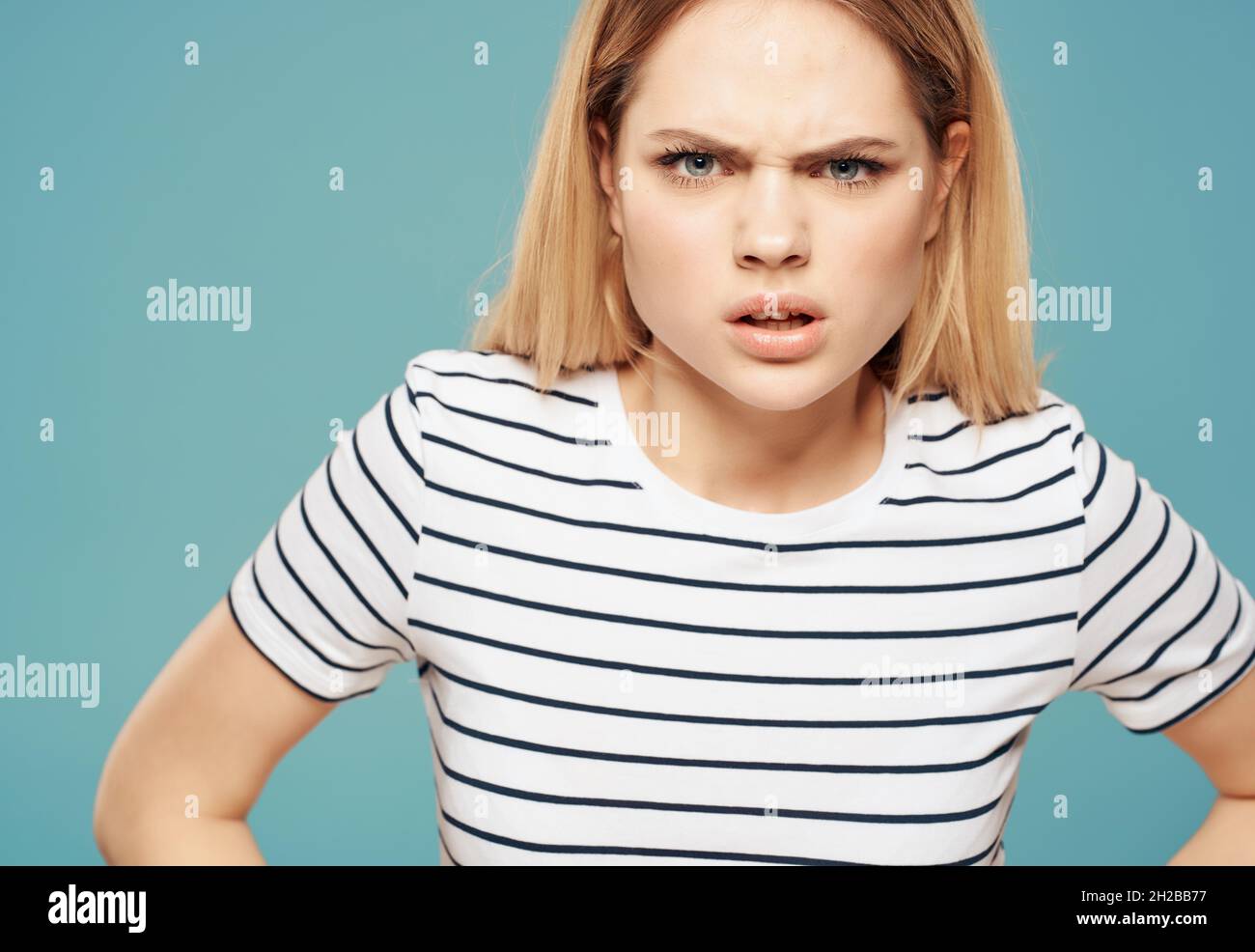 woman with displeased facial expression angry look blue background ...