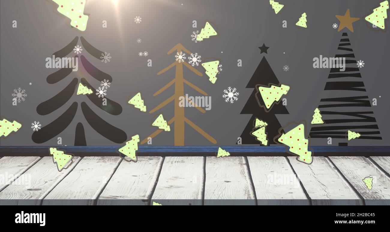 Image of snow and trees falling over christmas trees on black ...