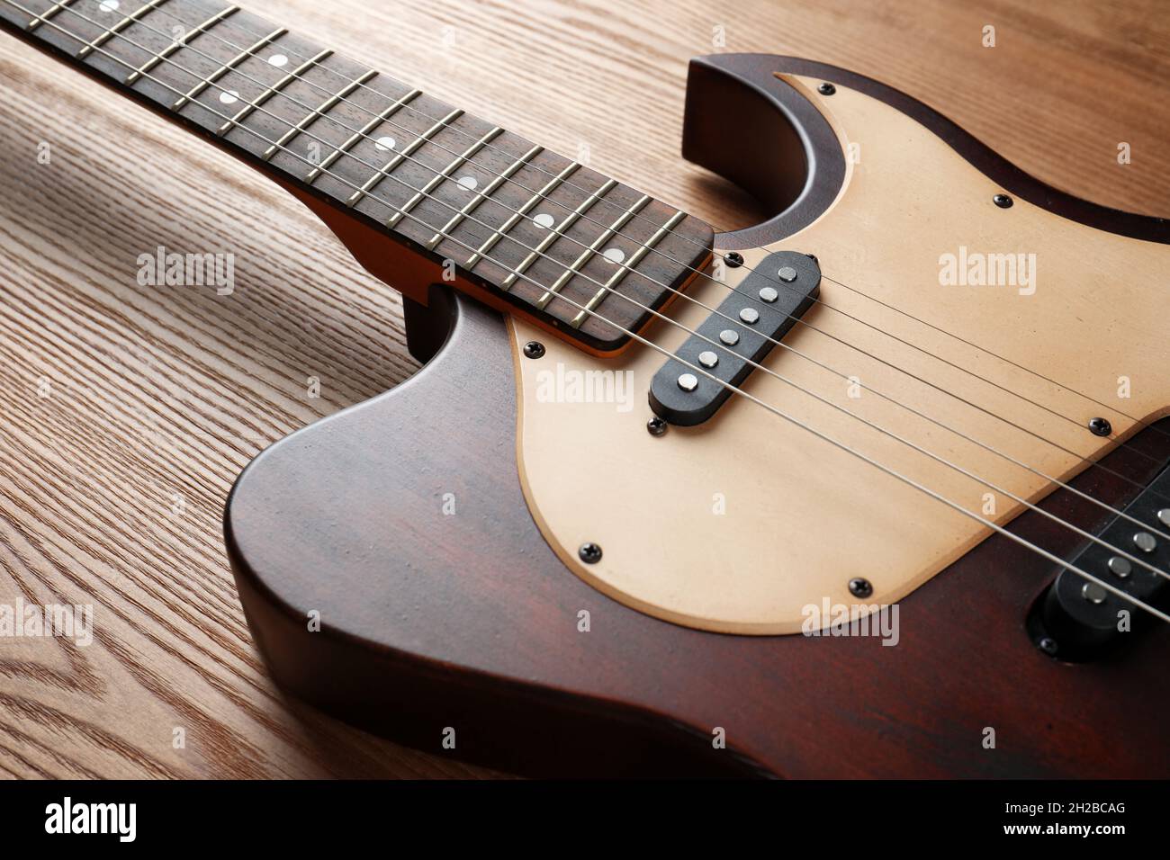 Modern electric guitar on wooden background. Musical instrument Stock ...