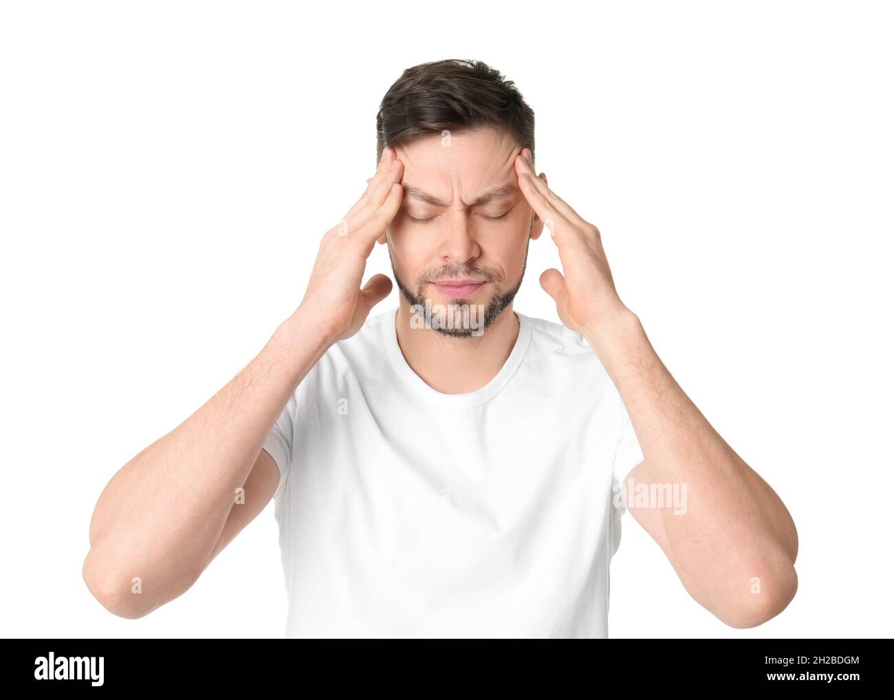 Man suffering from headache on white background Stock Photo - Alamy