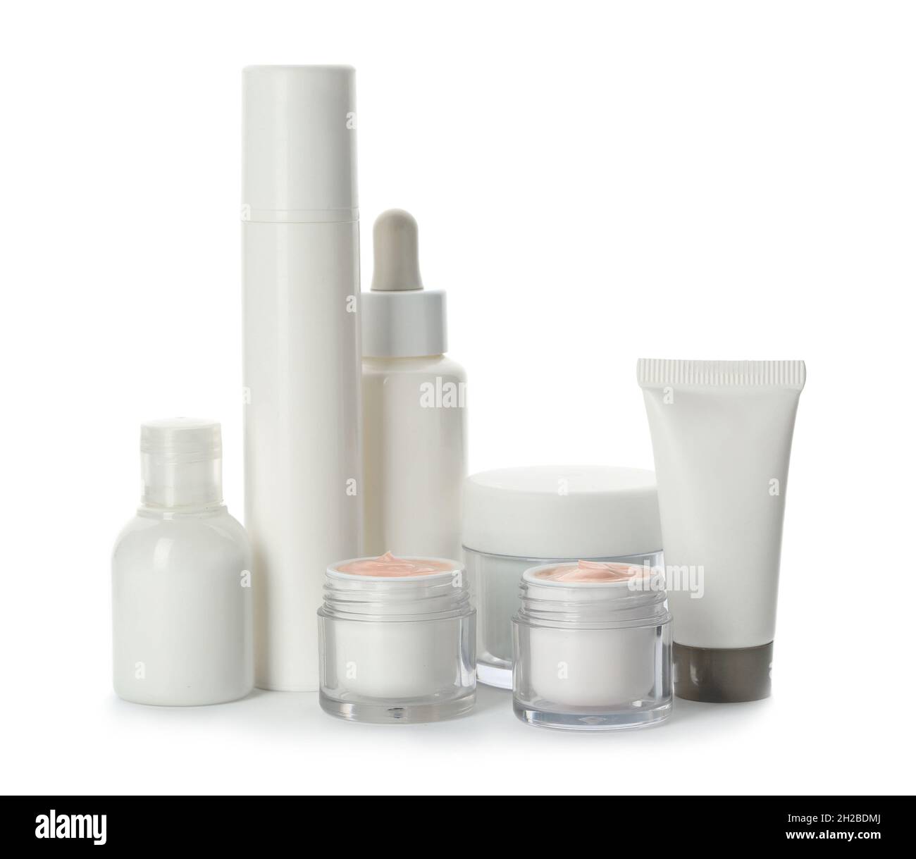 Different containers with hand cream and other cosmetic on white ...