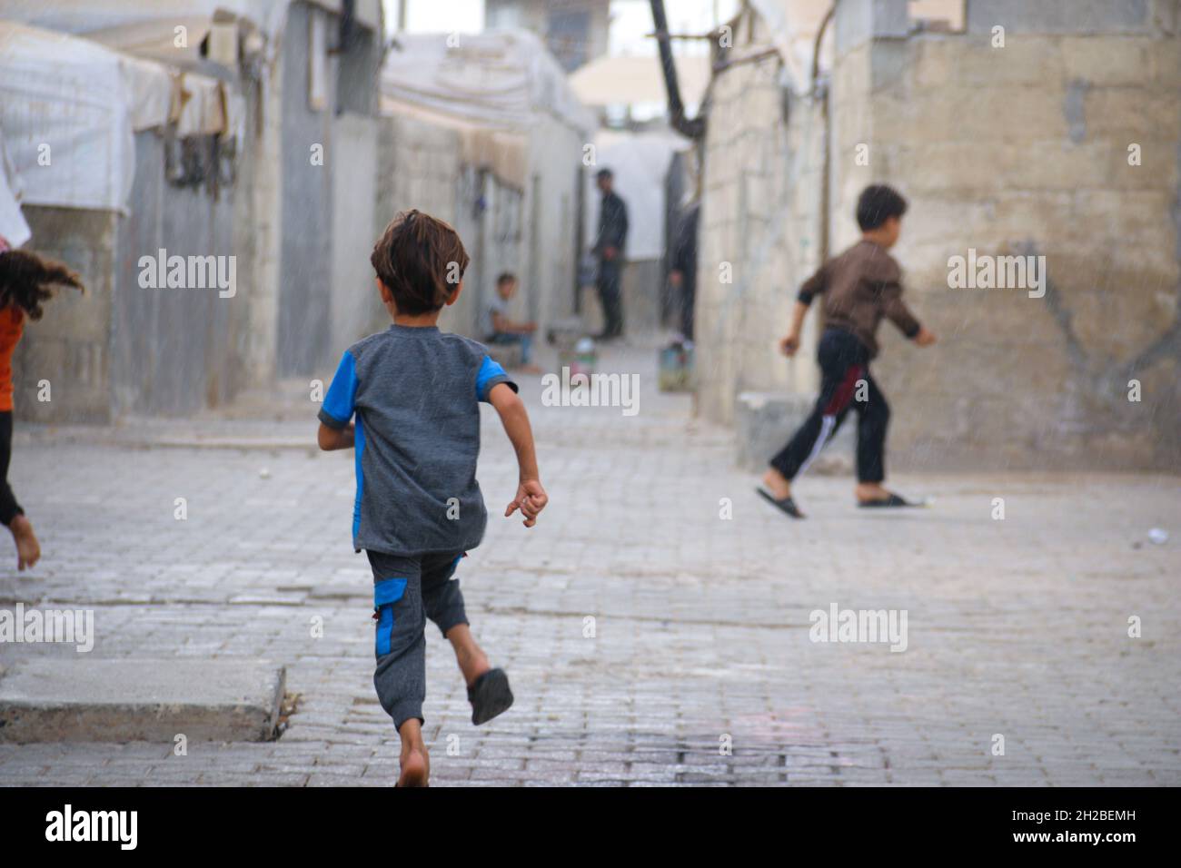 A portrait of a sweet refugee child in the camp. Syrian refugees Stock ...