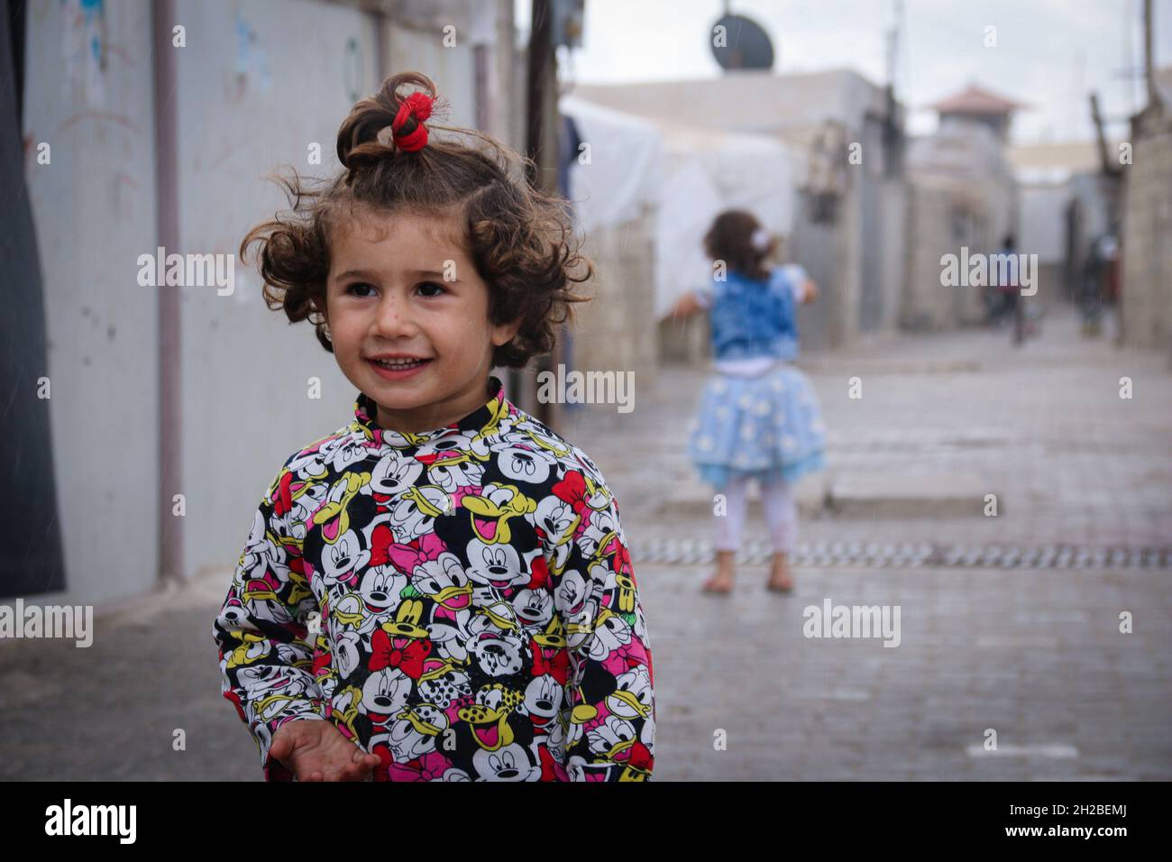 A portrait of a sweet refugee child in the camp. Syrian refugees Stock ...