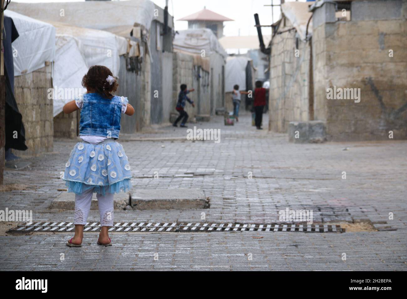 A portrait of a sweet refugee child in the camp. Syrian refugees Stock ...