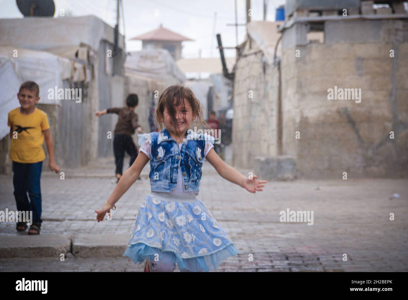 A portrait of a sweet refugee child in the camp. Syrian refugees Stock ...