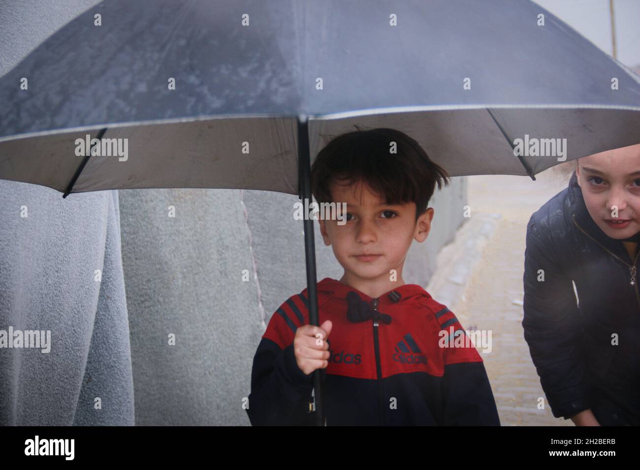 A portrait of a sweet refugee child in the camp. Syrian refugees Stock ...