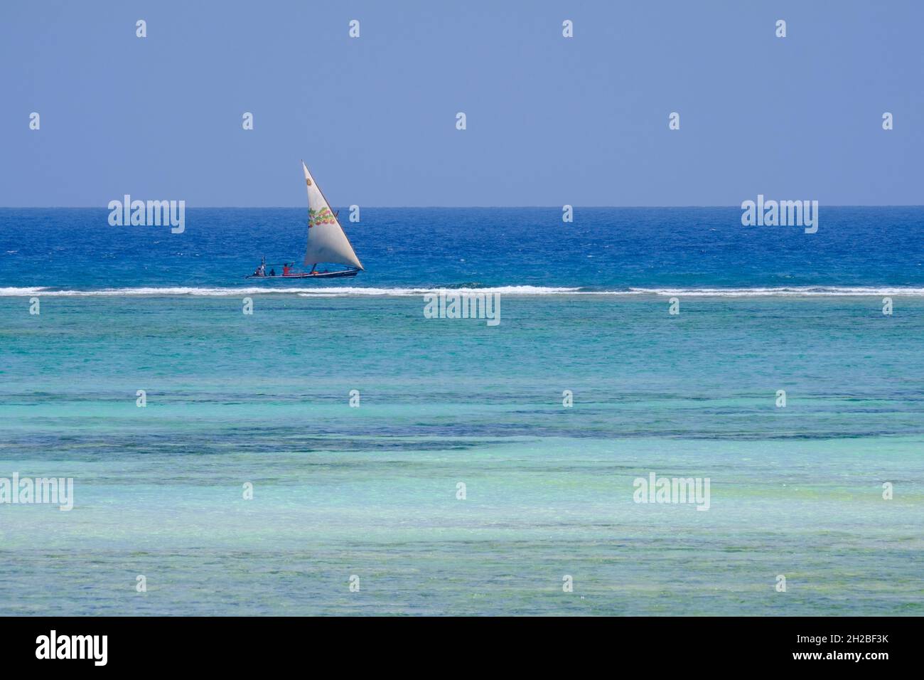 Fishing boat sailing turquoise waters of the island Zanzibar. Tanzania ...
