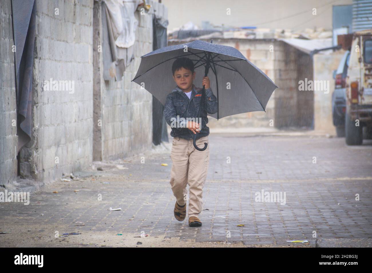 A portrait of a sweet refugee child in the camp. Syrian refugees Stock ...