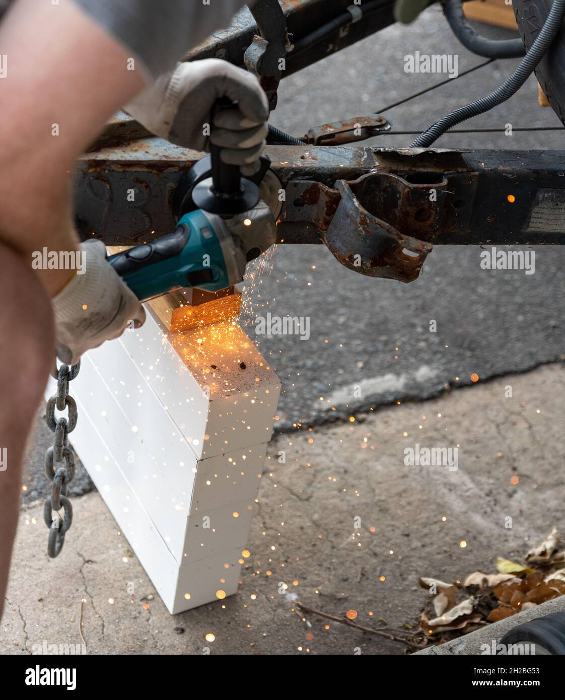 using a grinder machine to cut off a piece of metal Stock Photo - Alamy