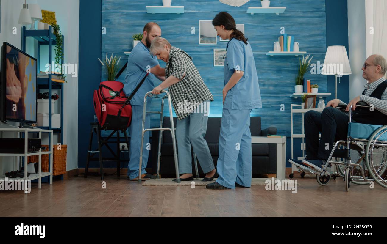 Nurse team helping old disabled hi-res stock photography and images - Alamy