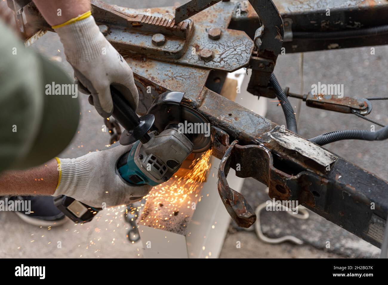 grinding off a piece of metal from a hitch Stock Photo - Alamy