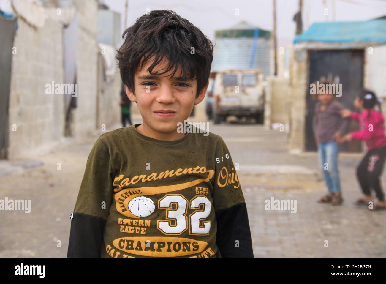 A portrait of a sweet refugee child in the camp. Syrian refugees Stock ...