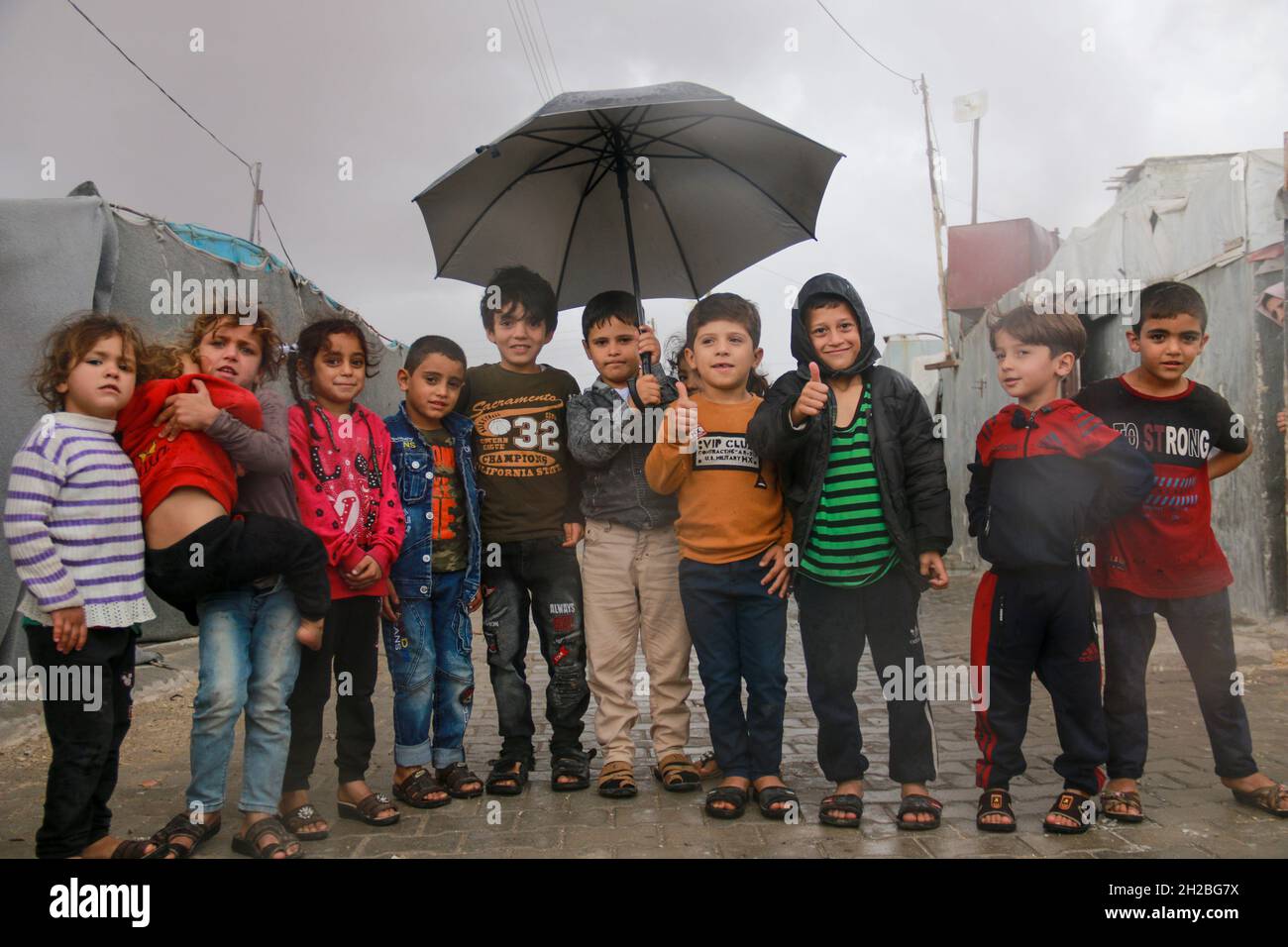 A portrait of a sweet refugee child in the camp. Syrian refugees Stock ...