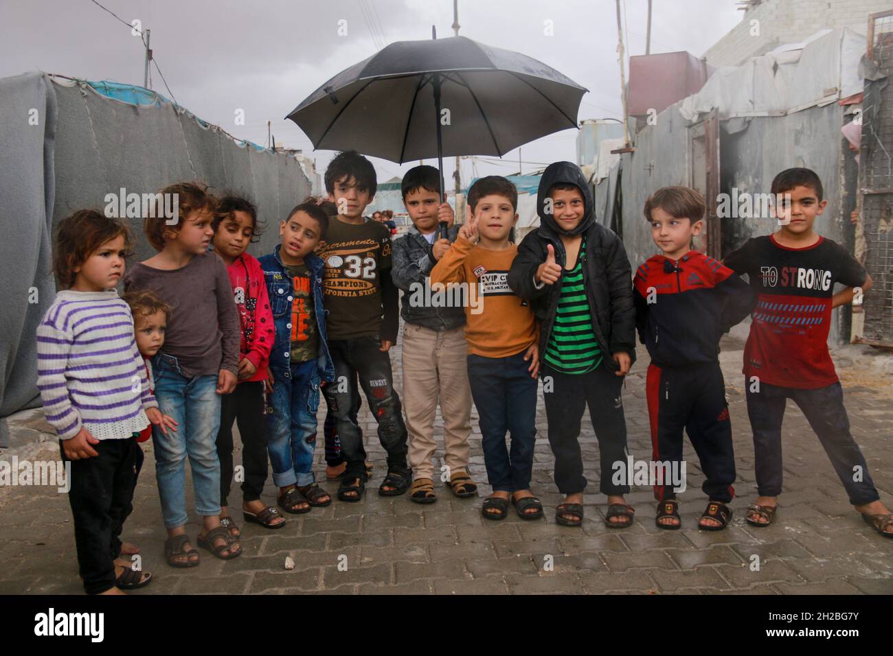 A portrait of a sweet refugee child in the camp. Syrian refugees Stock ...