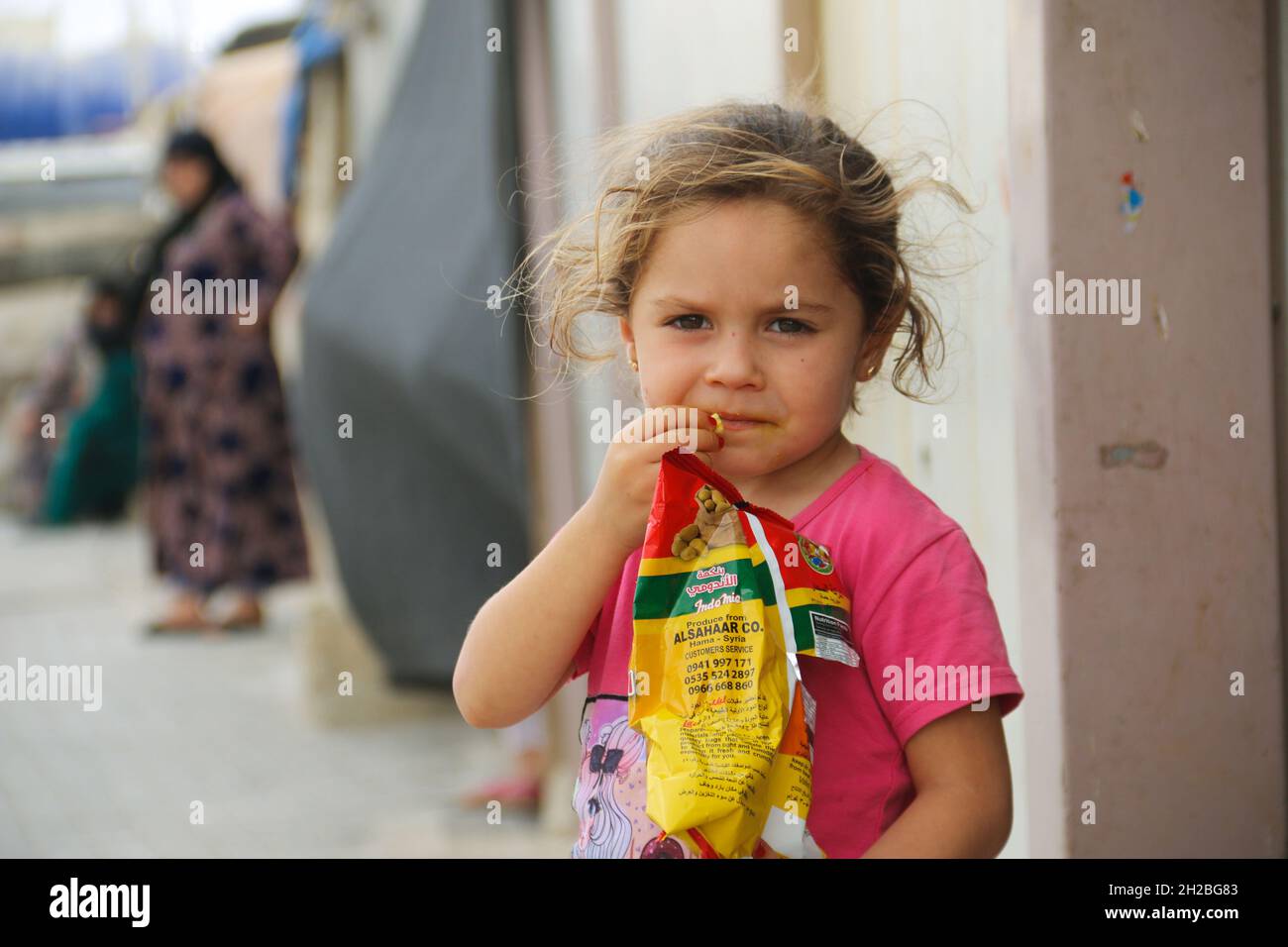 A portrait of a sweet refugee child in the camp. Syrian refugees Stock ...