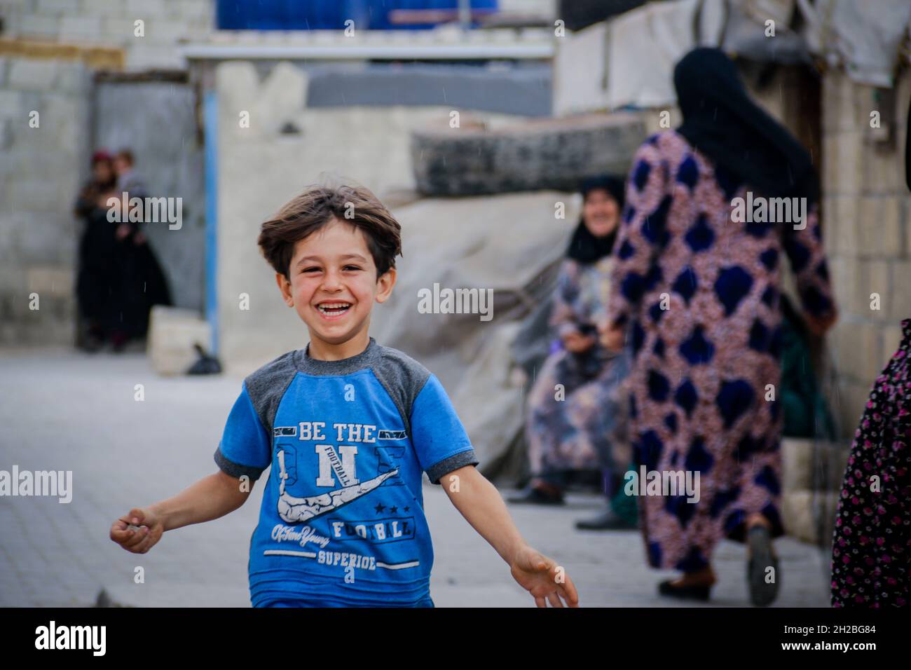 A portrait of a sweet refugee child in the camp. Syrian refugees Stock ...
