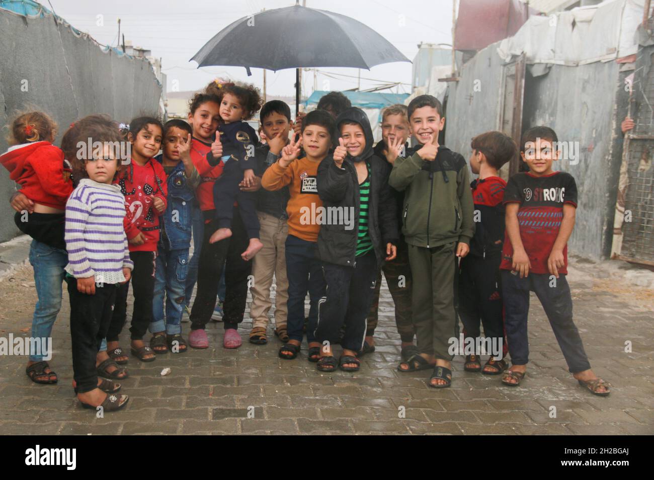 A portrait of a sweet refugee child in the camp. Syrian refugees Stock ...