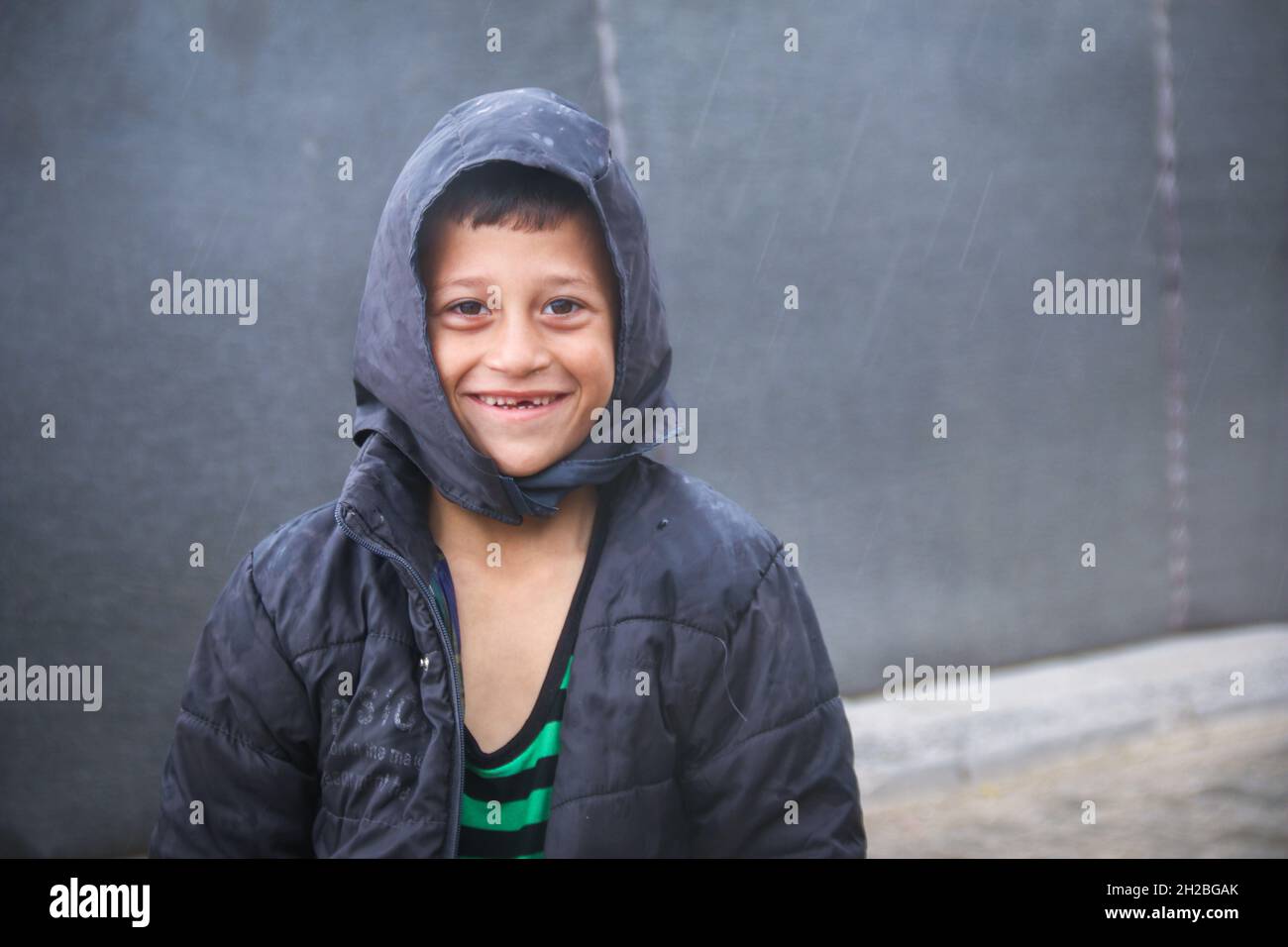 A portrait of a sweet refugee child in the camp. Syrian refugees Stock ...